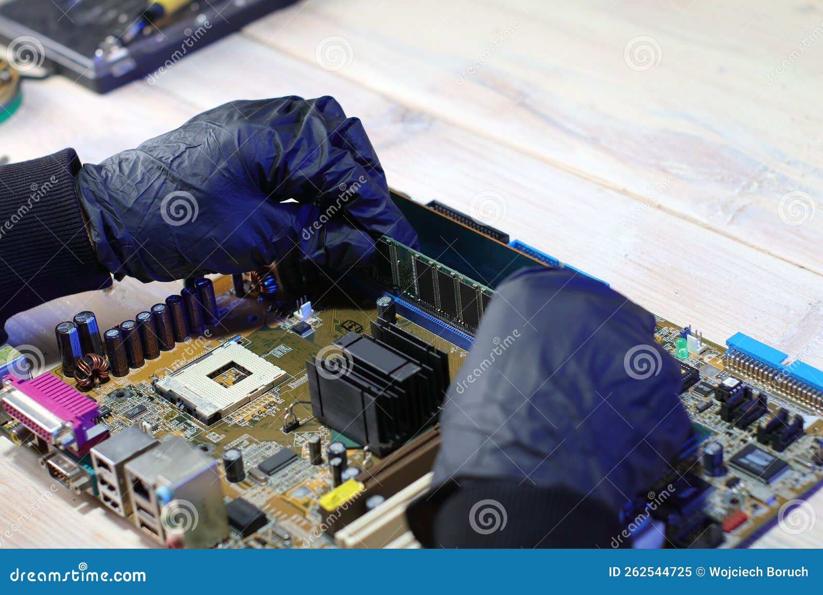 Inserting Ram Into Motherboard From Computer On Table Royalty-Free ...