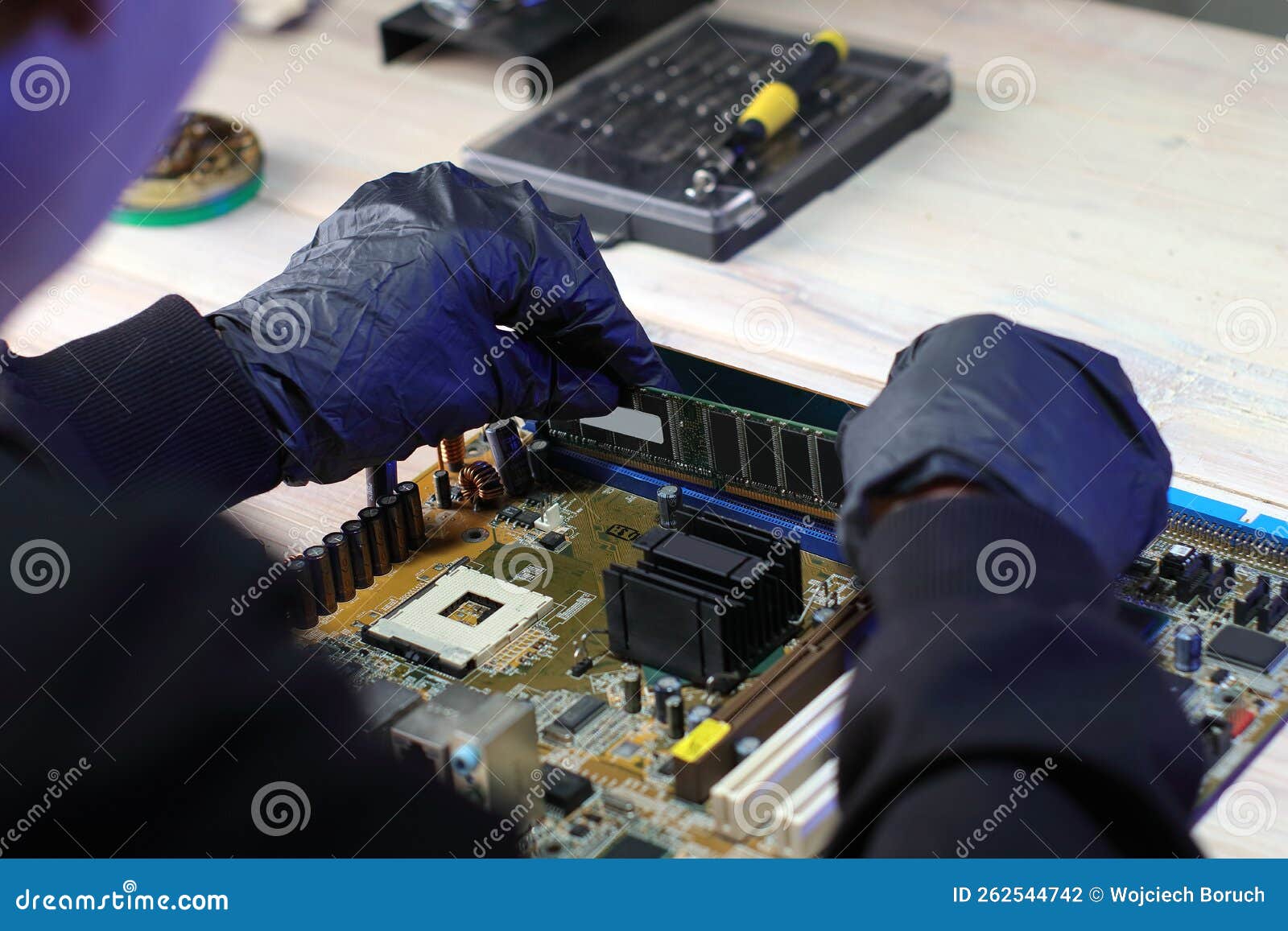 Inserting Ram Into Motherboard From Computer On Table Royalty-Free ...