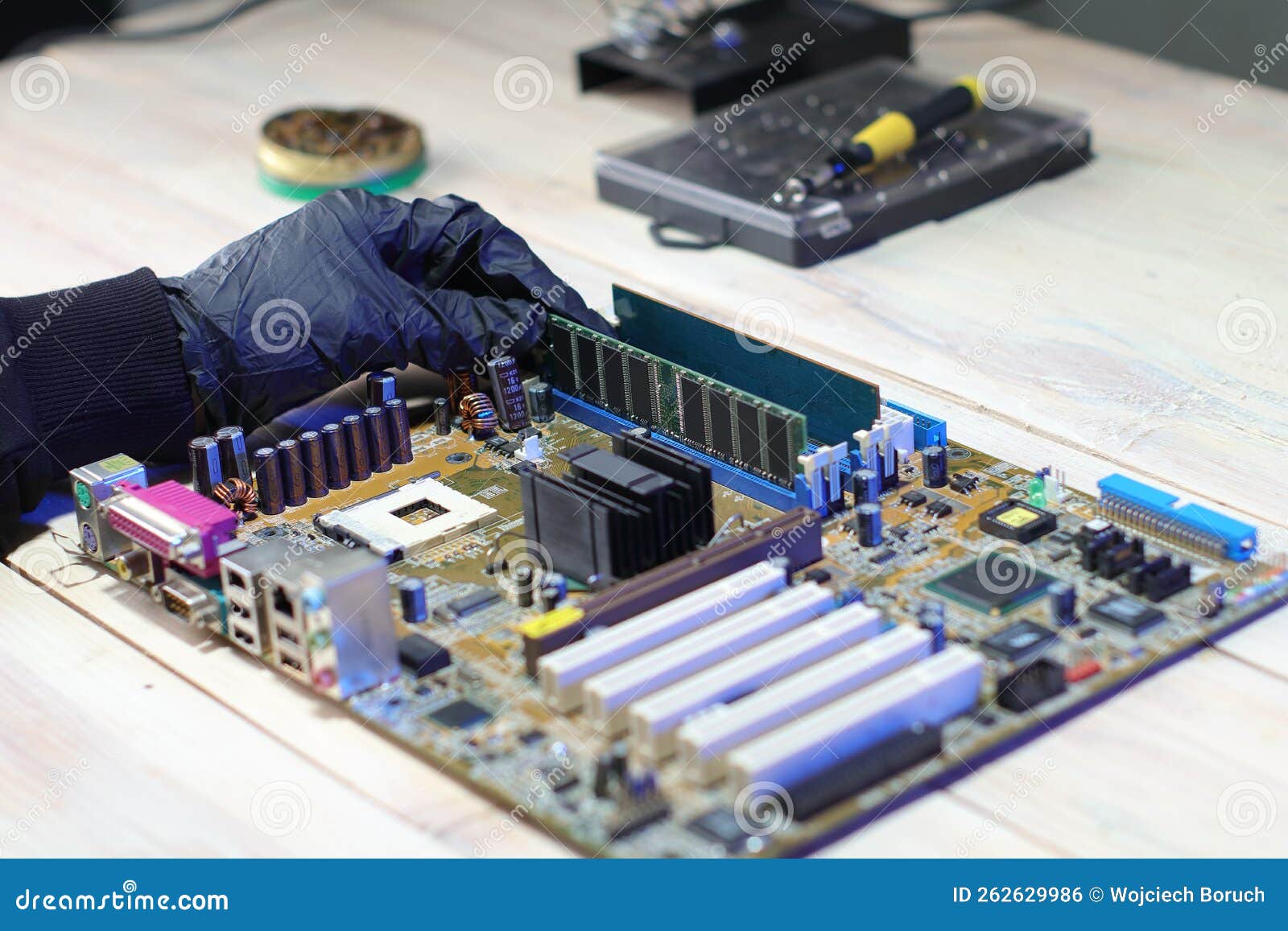 Inserting Ram into Motherboard from Computer on Table Stock Photo ...