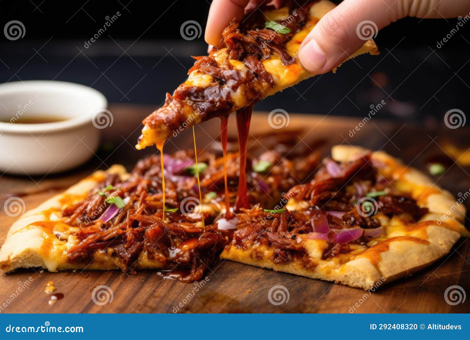 Inserting a Slice of Bbq Pizza into a Beer-infused Sauce Stock Photo ...