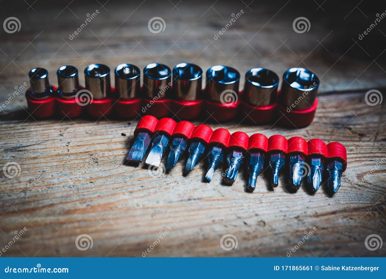 Inserts of a Socket Spanner with a Red Cap Lying on a Wooden Surface ...