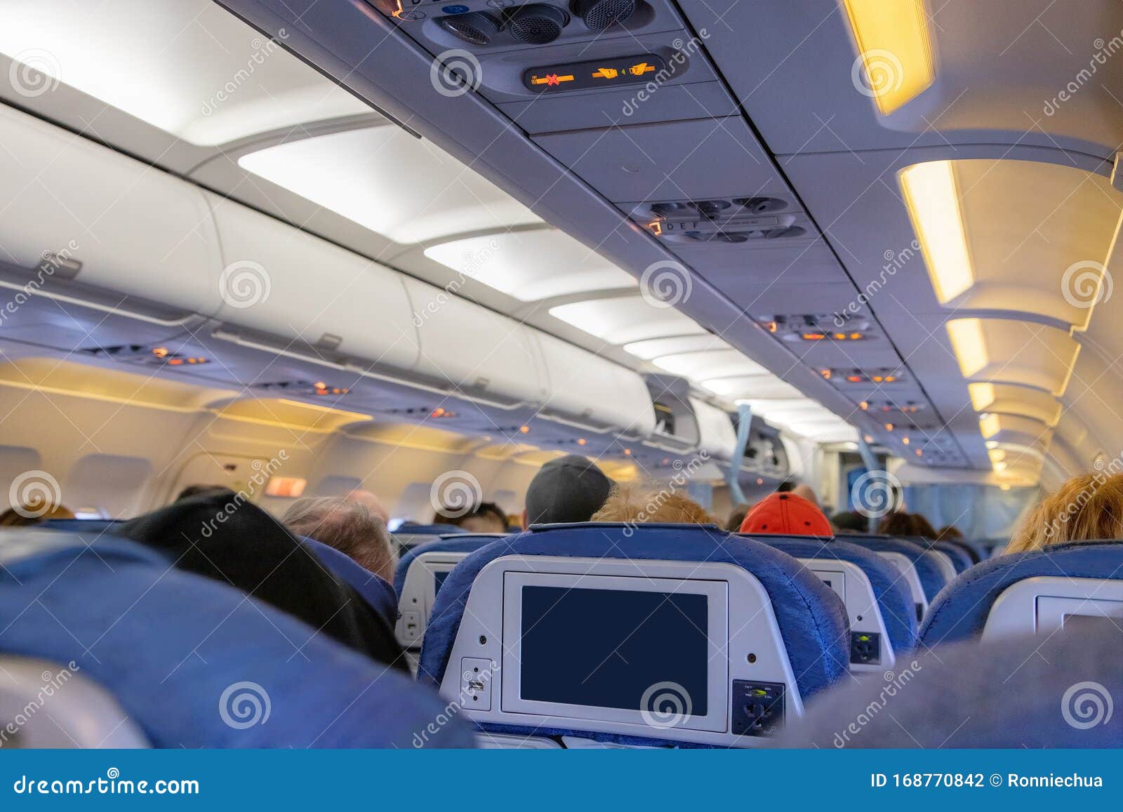 Inside of an Airplane Cabin with Passengers on Flight Stock Photo ...