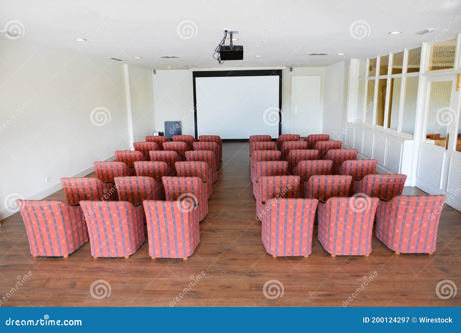 Inside of a Conference Hall with Set-up Chairs and a Screen on the Wall ...