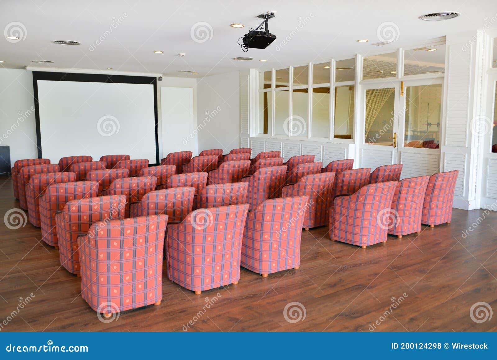 Inside of a Conference Hall with Set-up Chairs and a Screen on the Wall ...