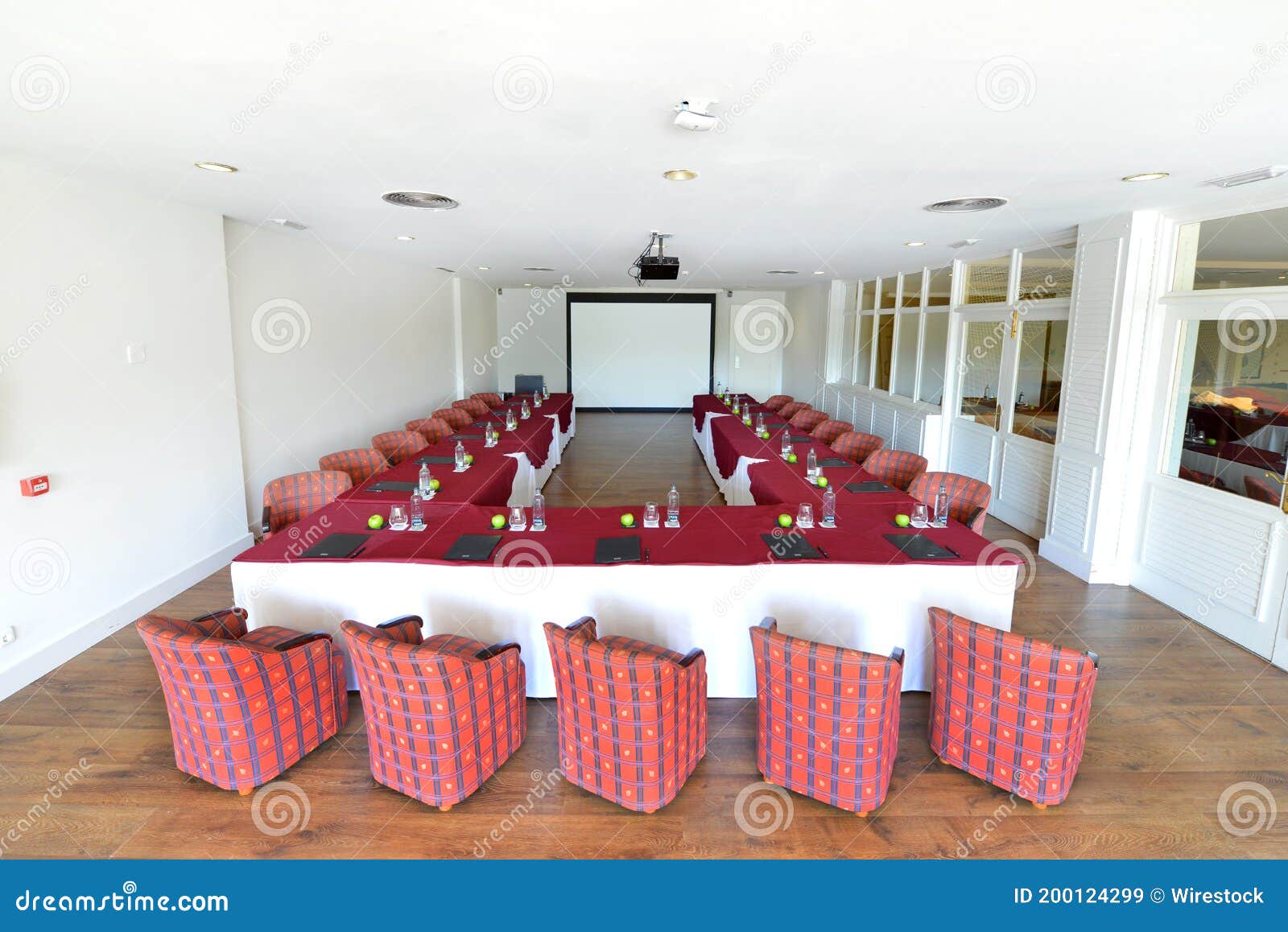 Inside of a Conference Hall with Set-up Chairs and Tables and a Screen ...