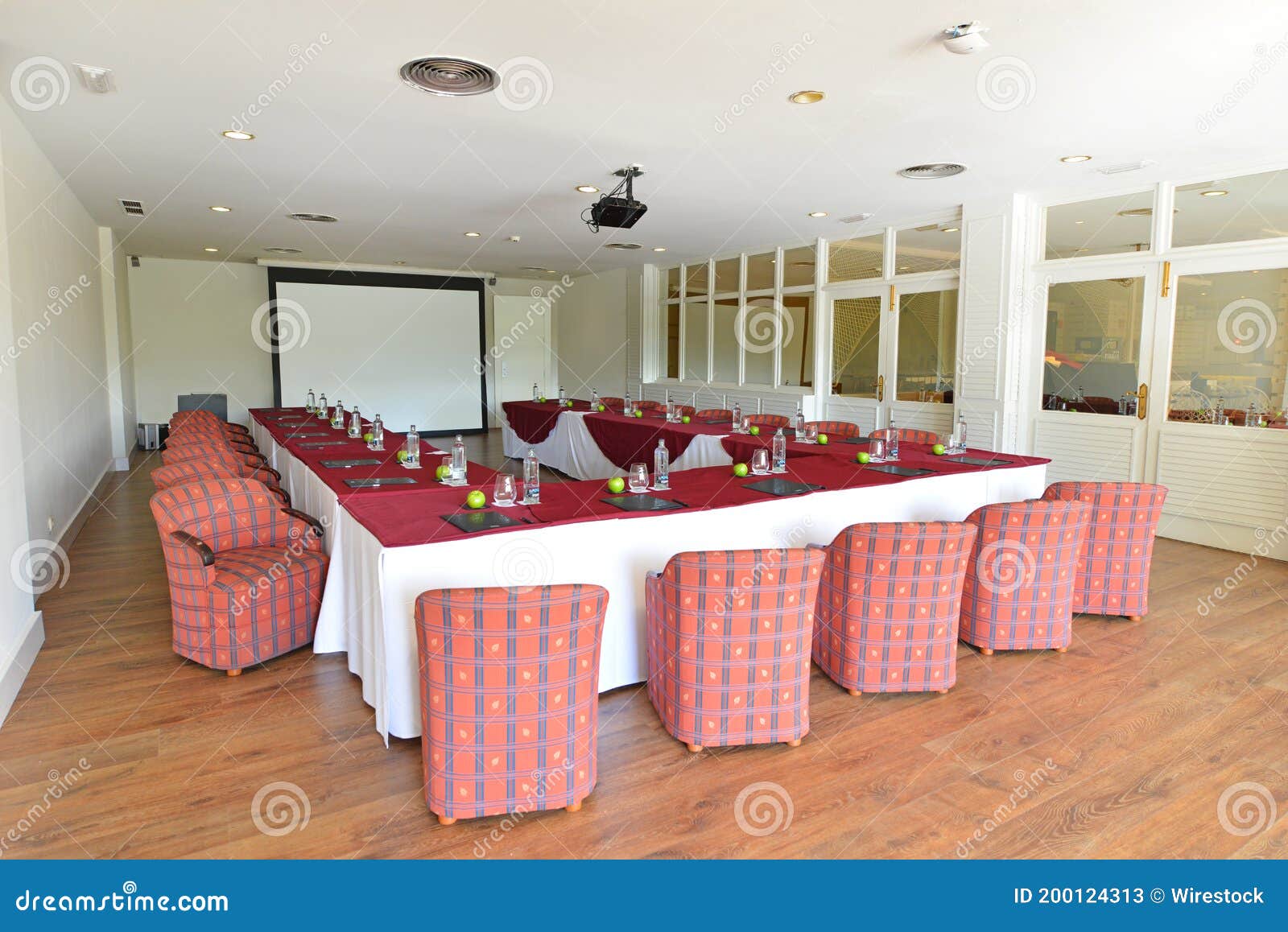 Inside of a Conference Hall with Set-up Chairs and Tables and a Screen ...