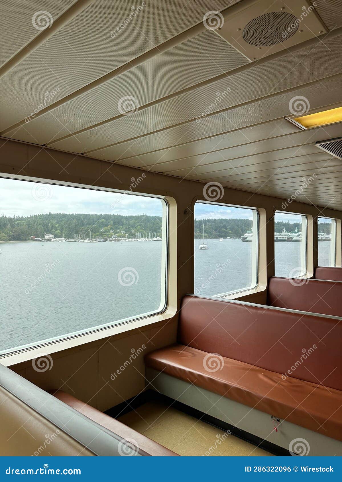 The Inside of an Empty Passenger Ferry is Shown with Several Benches ...