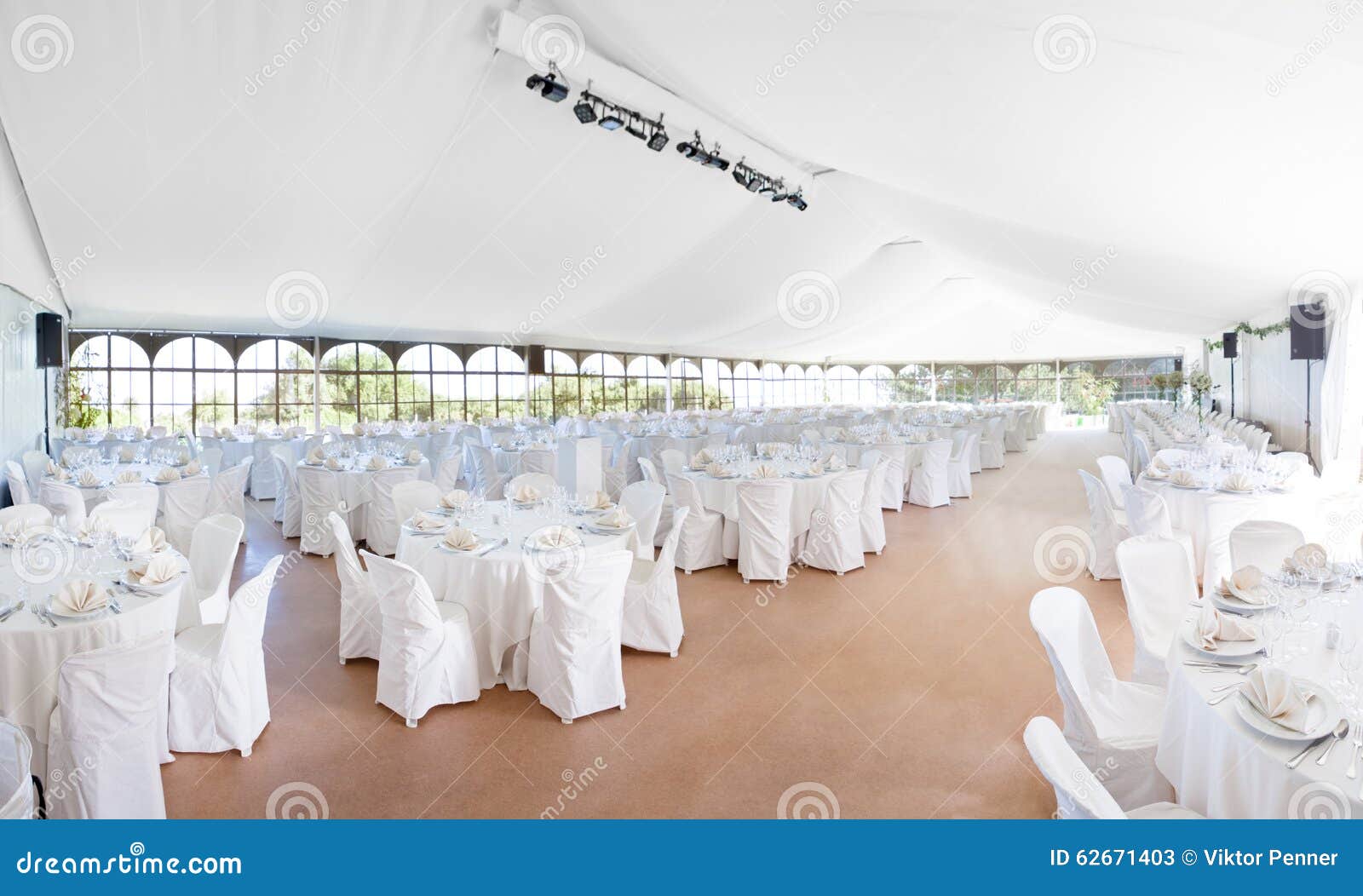 Inside a Large Wedding Tent Set Up for an Reception with Rows of Tables ...