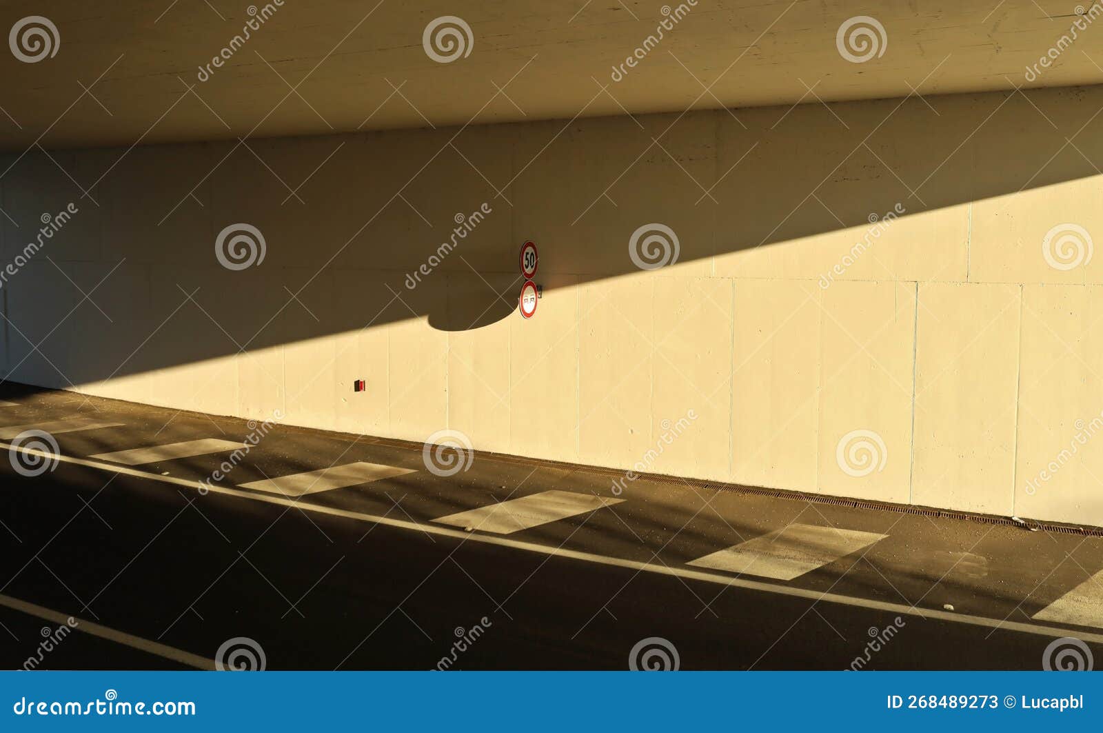 Inside of an Underpass with Concrete Wall with Two Road Sign, Divided ...