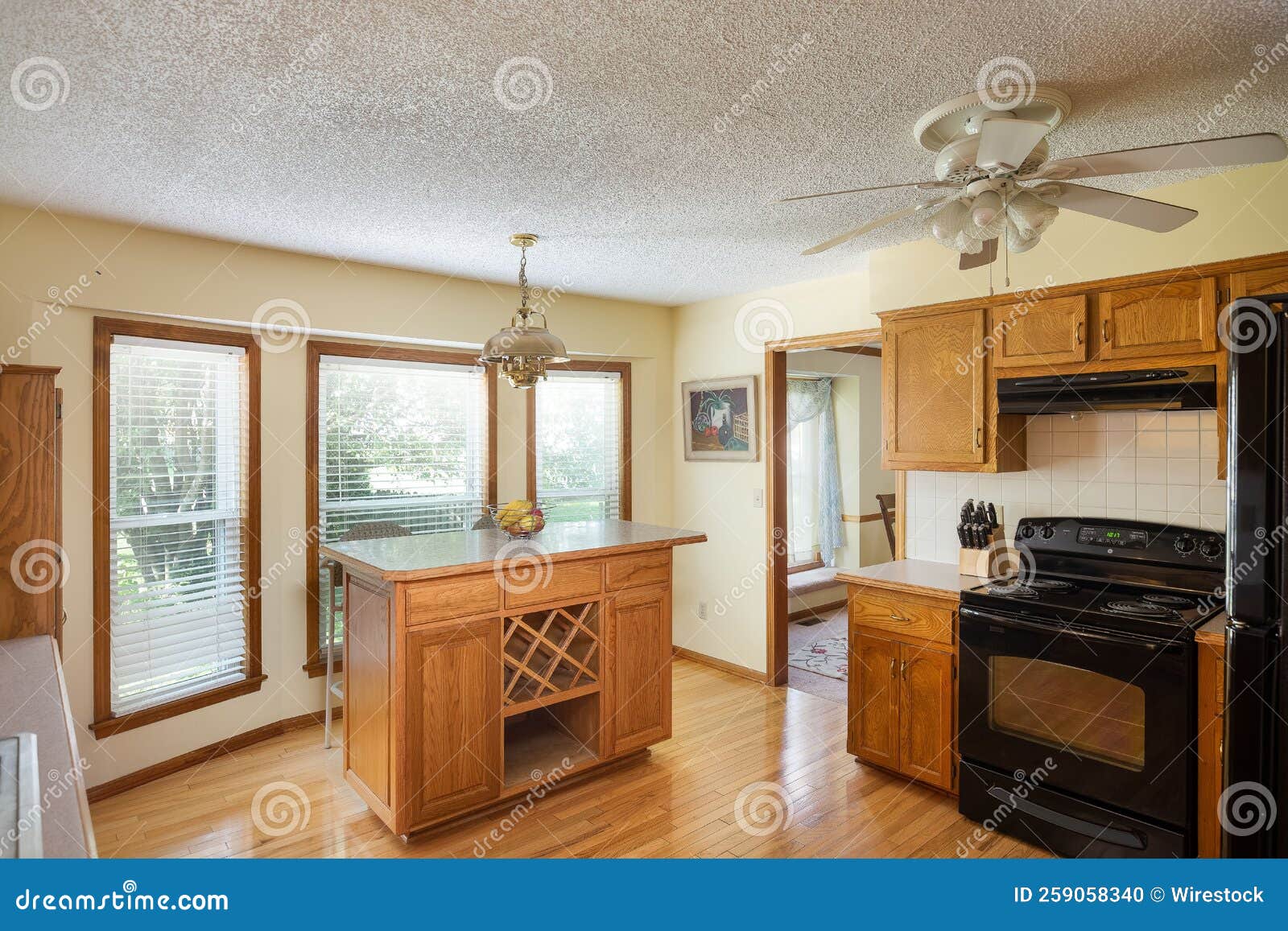 Inside View of a Cozy Modern Kitchen with a Table, Black Fridge, and ...