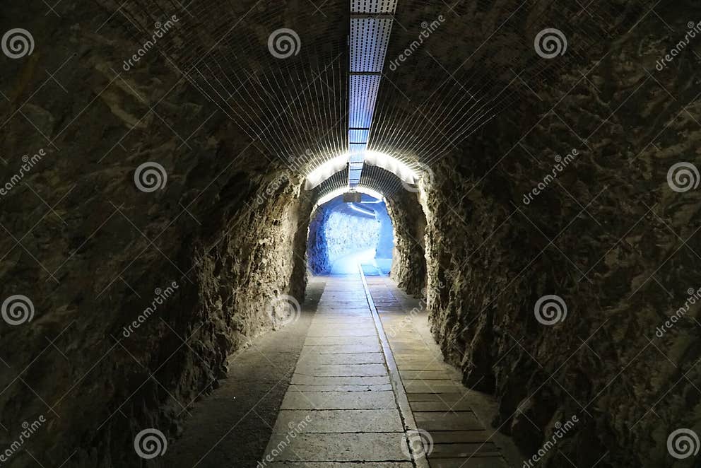 Inside View of an Old Underground Tunnel with a Blue Light at the End ...