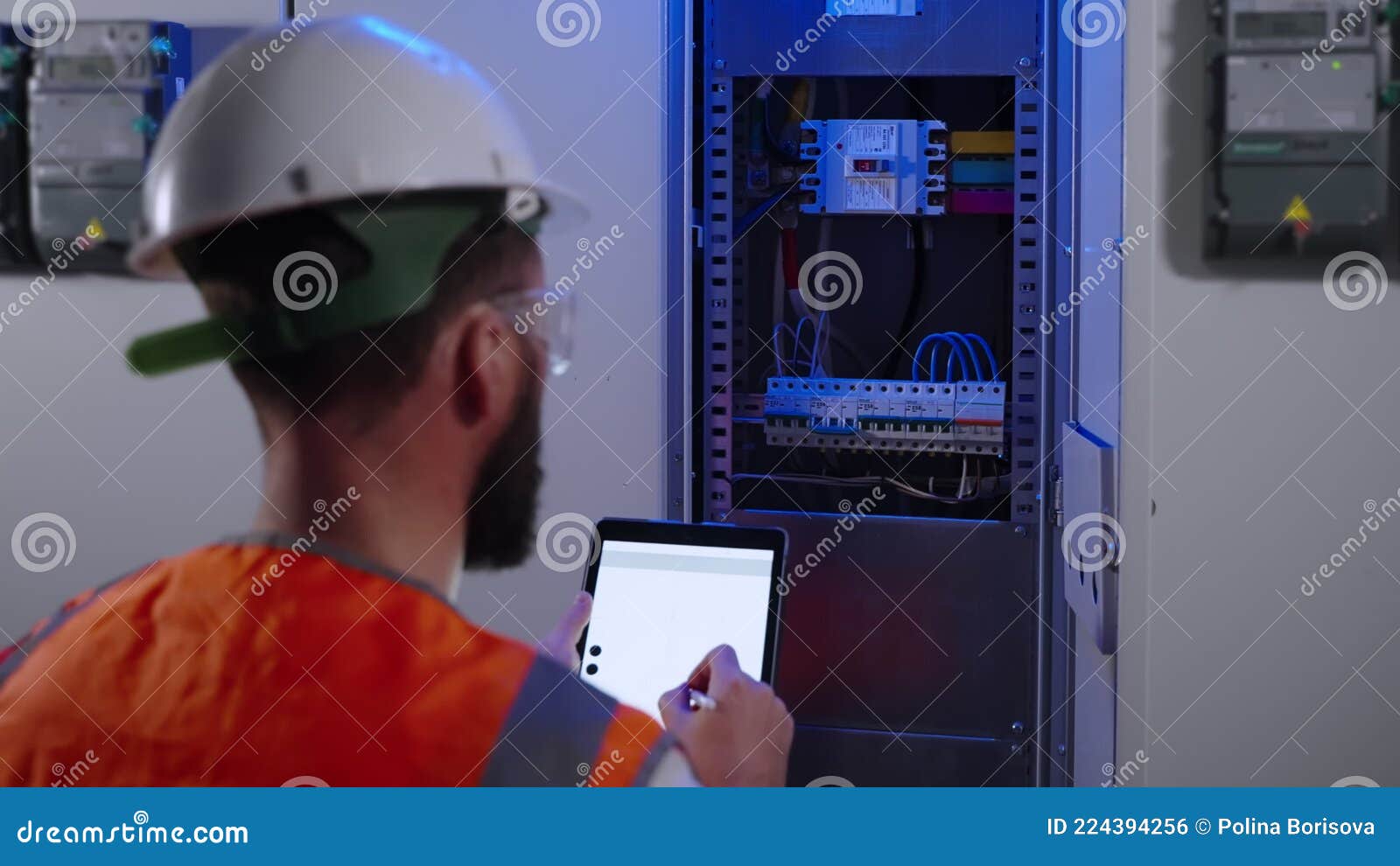 Inspection of Switchboard. Electrician with Digital Tablet Checking ...