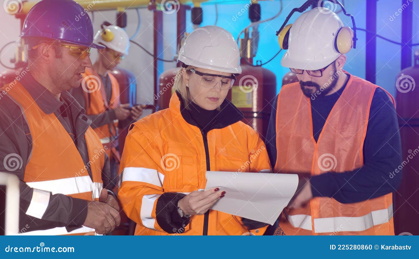 Inspector with Engineers Reads Papers at Industrial Complex Stock Photo ...