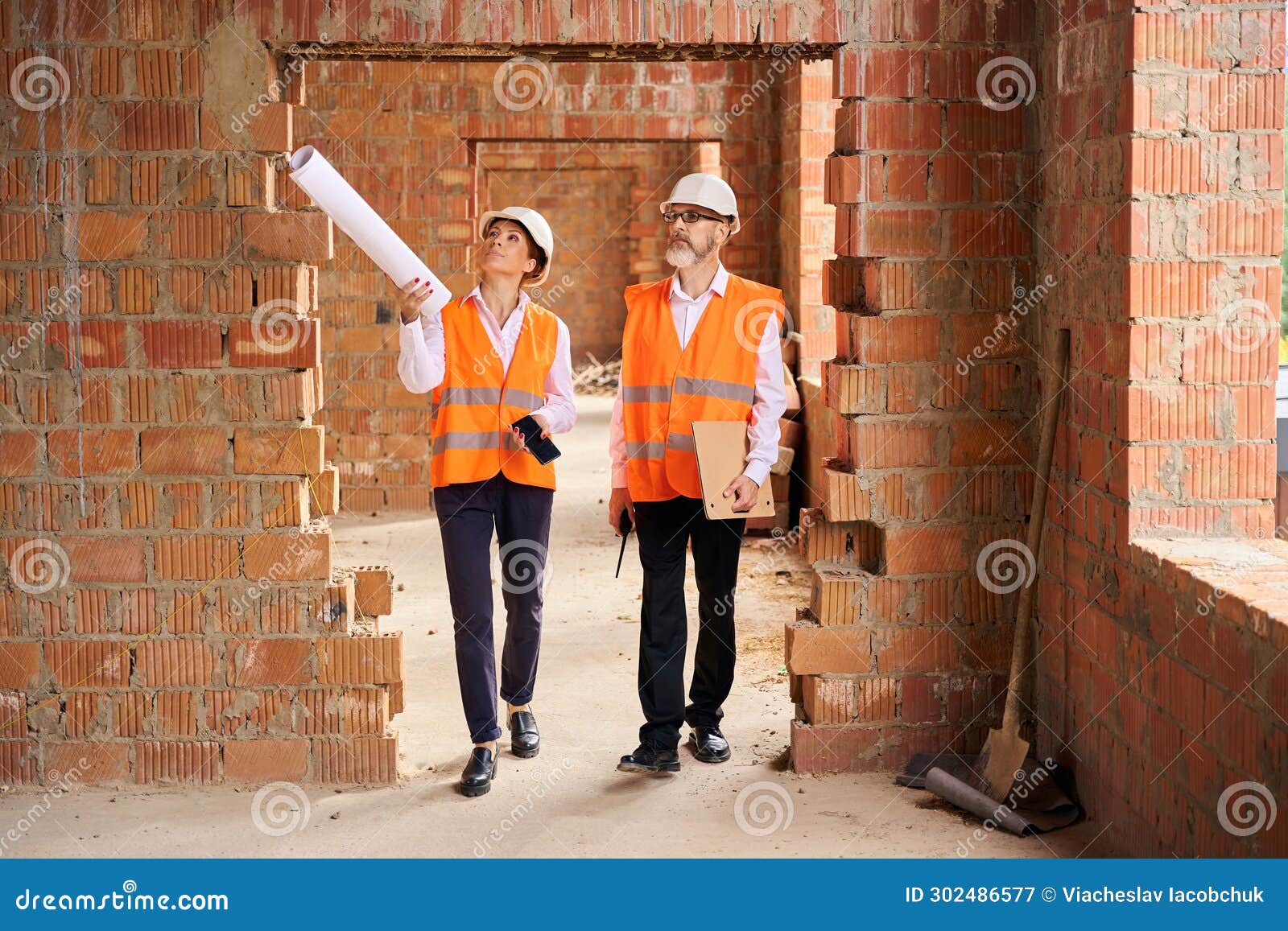 Inspector and Foreman Inspecting Interior of Half-constructed Dwelling ...