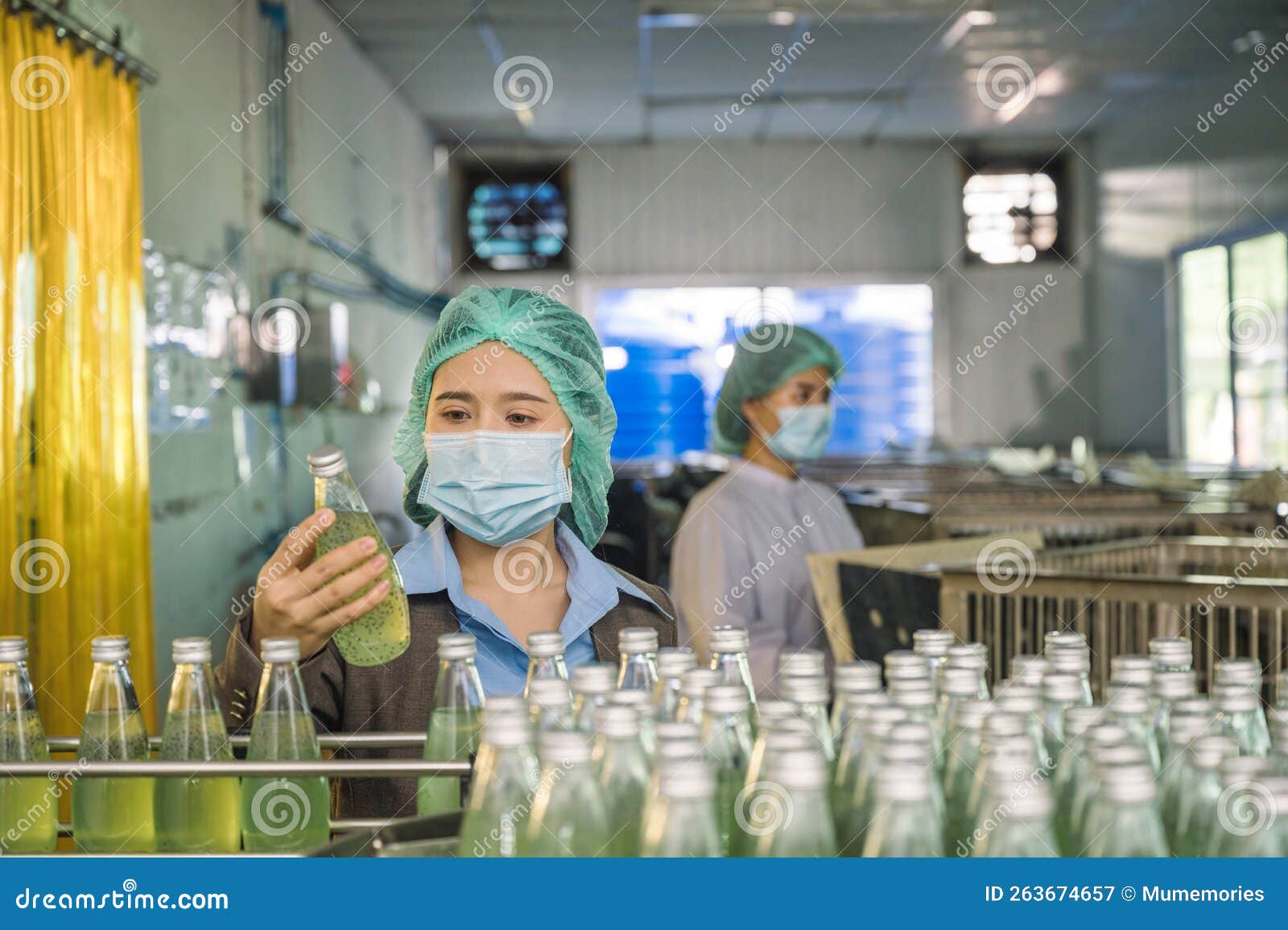 Inspector Woman Checking a Bottled Fruit Beverage on Conveyer ...