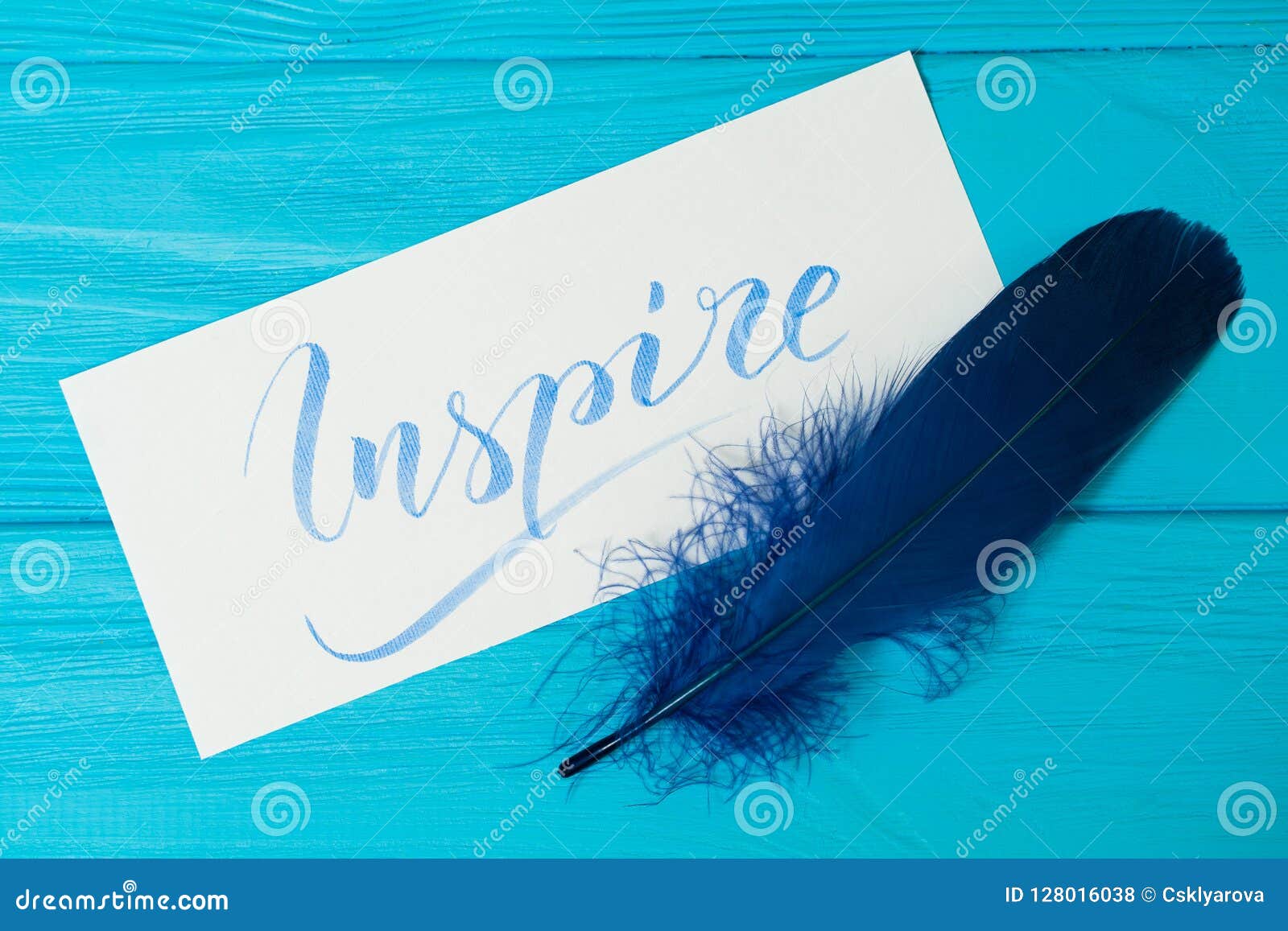 Inspire. Beautiful Blue Letters on Canvas with Blue Feather ...