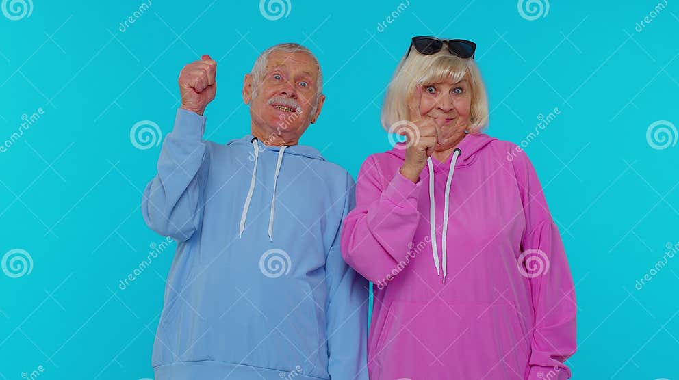 Inspired Senior Grandmother With Grandpa Pointing Finger Up With Open Mouth Showing Eureka