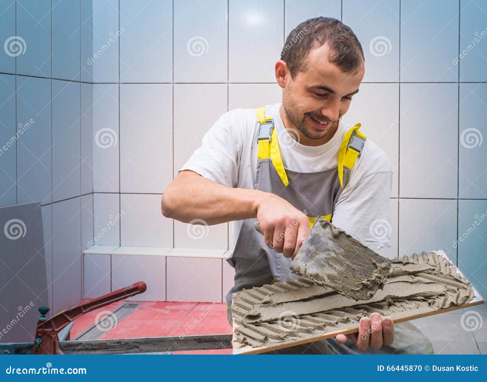 Install ceramic tiles stock photo. Image of plaster, male - 66445870