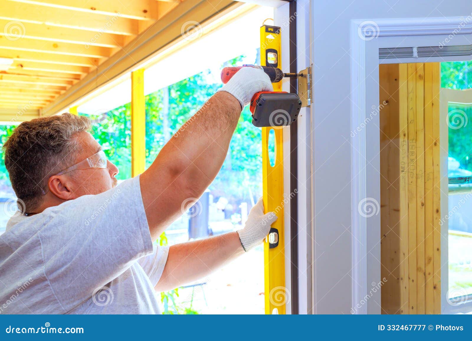 An Installation of Carpenter Utilizes Screwdriver To Install Front Door ...