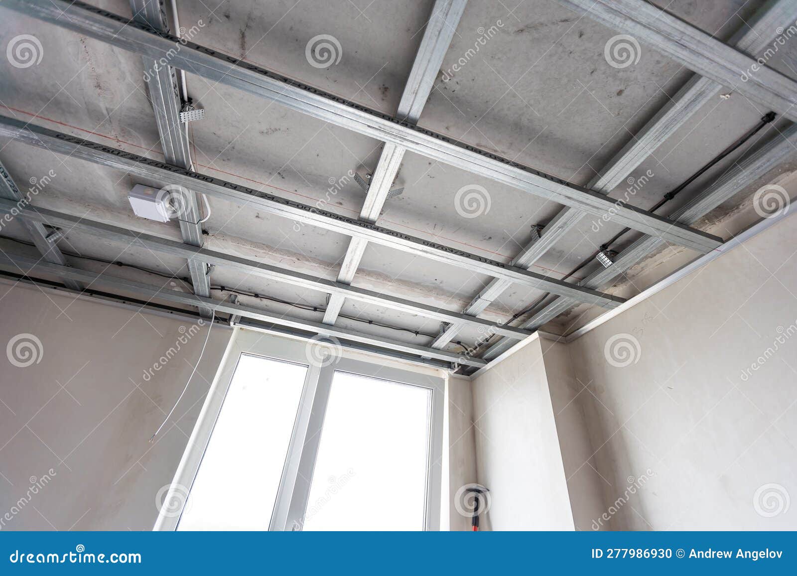 Installation of Drywall. Workers are Using Screws and a Screwdriver To ...