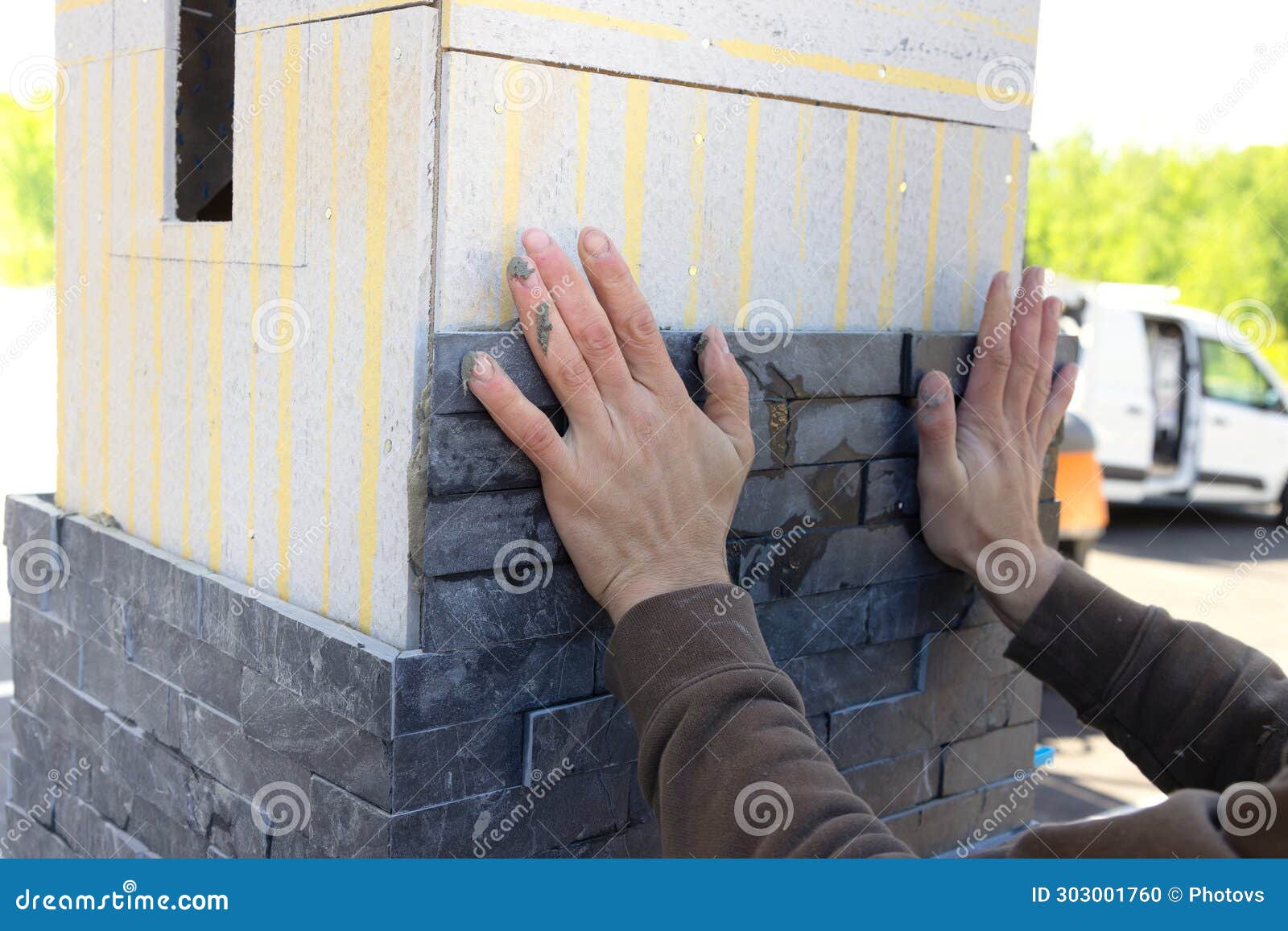 Installation of Facing Tiles on Building Columns is Performed by a ...