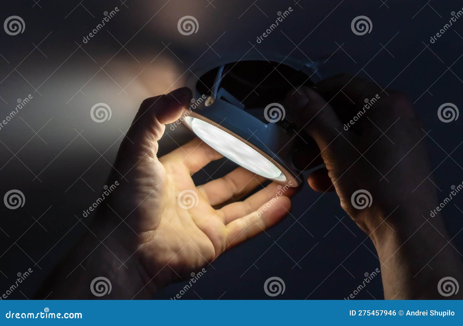 Installation of a Light Bulb in a Stretch Ceiling Stock Photo - Image ...