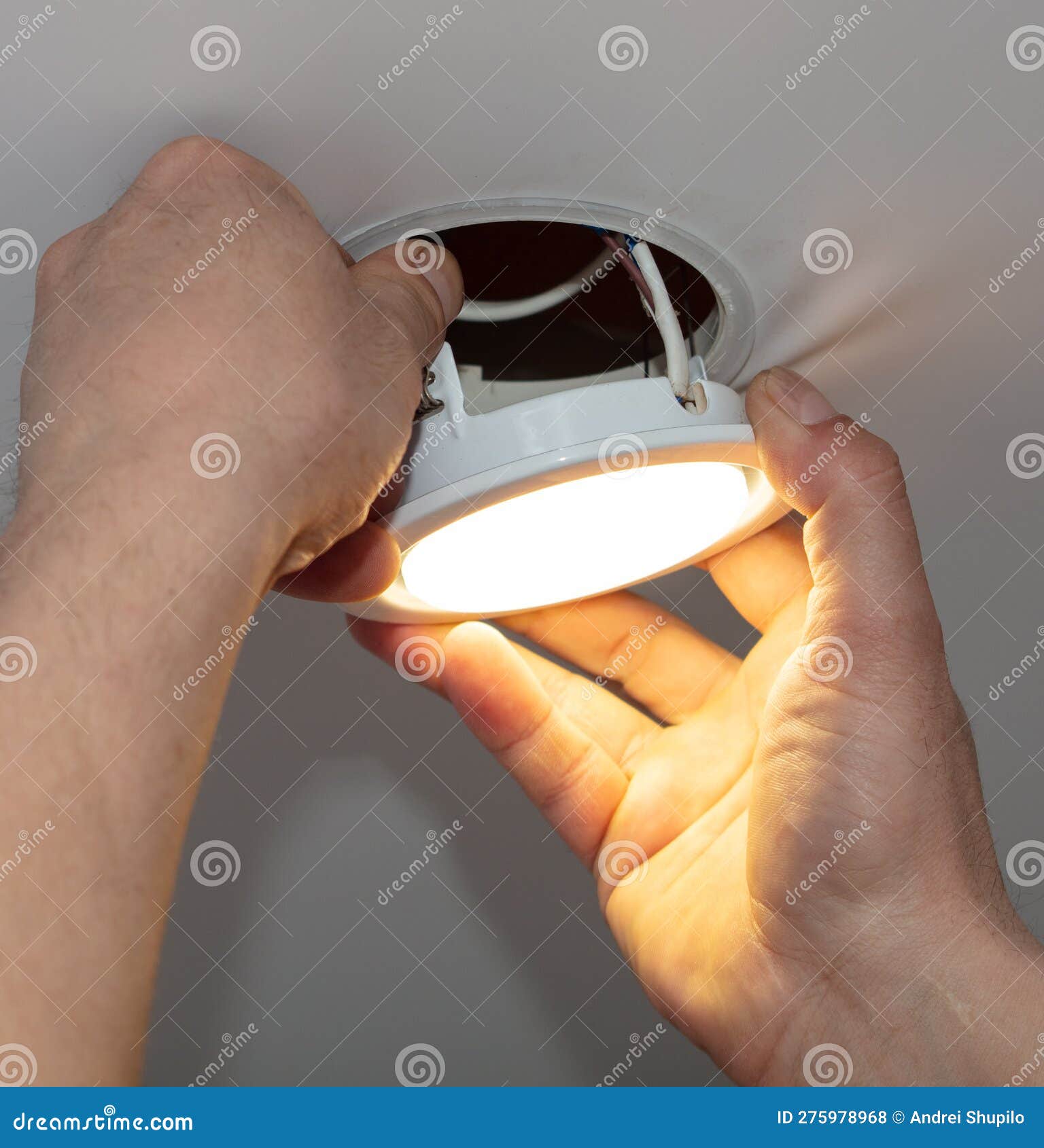 Installation of a Light Bulb in a Stretch Ceiling Stock Photo - Image ...