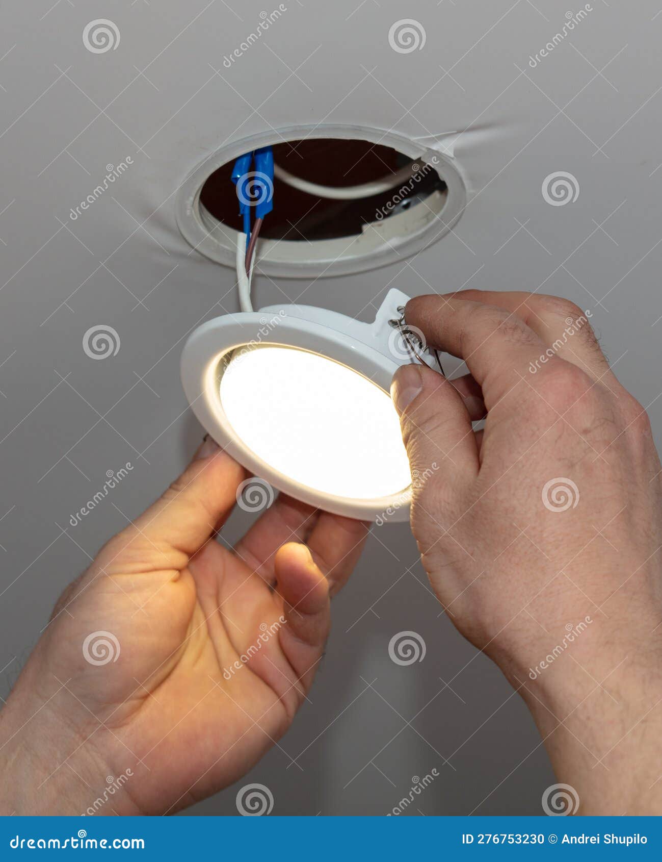 Installation of a Light Bulb in a Stretch Ceiling Stock Photo - Image ...