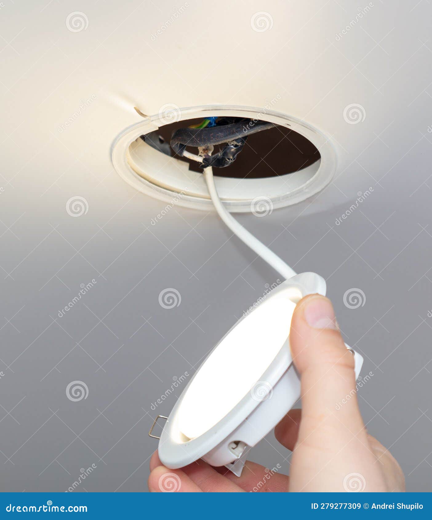 Installation of a Light Bulb in a Stretch Ceiling Stock Image - Image ...
