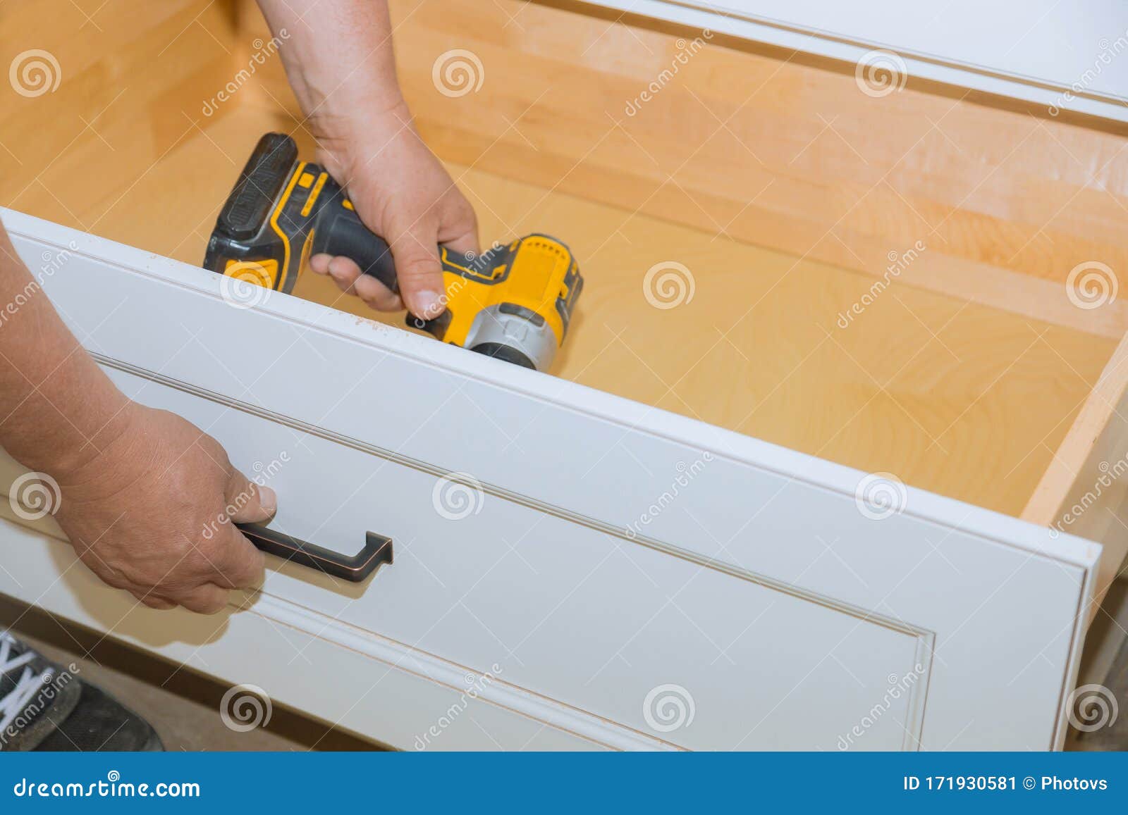 Installation of Drawers Handles on Kitchen Cabinets Stock Image - Image ...