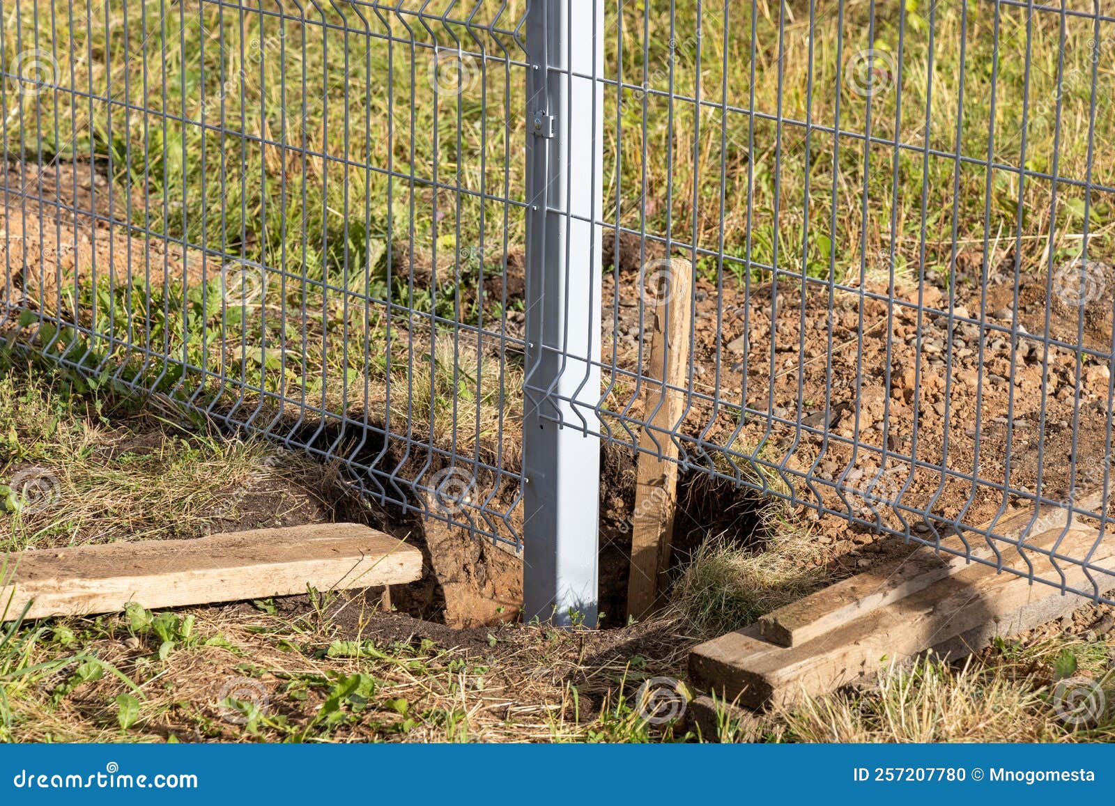 Installation of a Metal Fence. the Process of Installing Support Poles ...