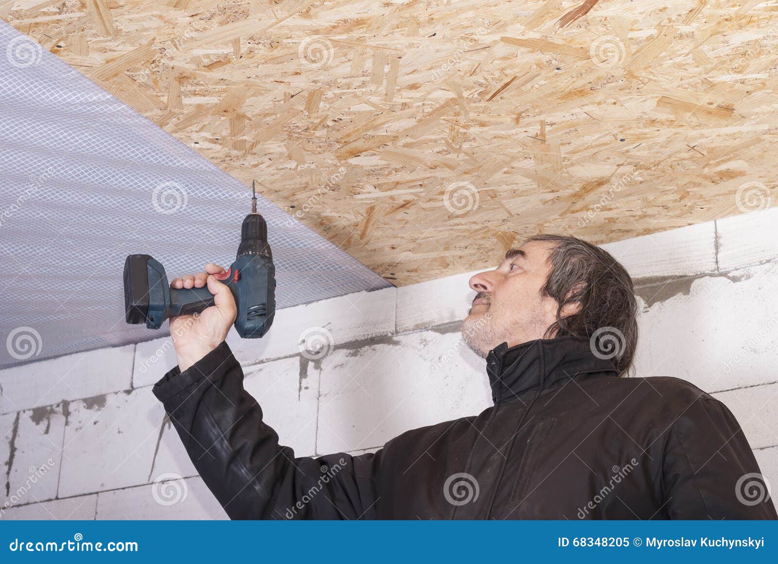 Builder Twists The In The OSB Sheet On The Ceiling Royalty-Free Stock ...