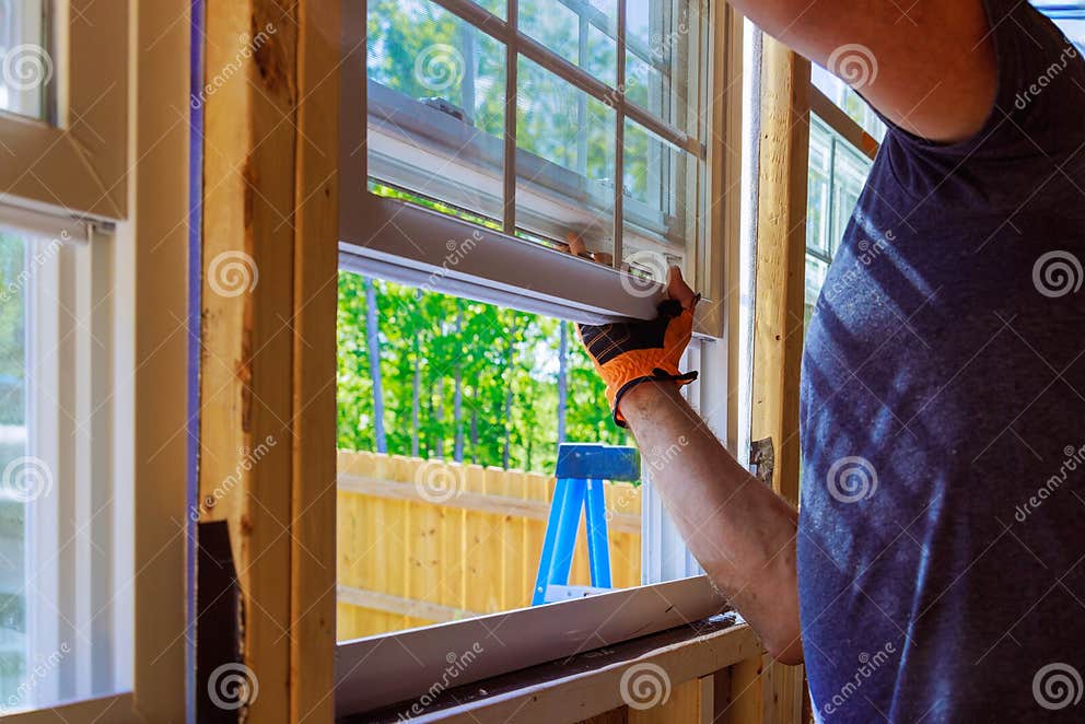 An Installation of Plastic Windows in New Home is Performed by a ...