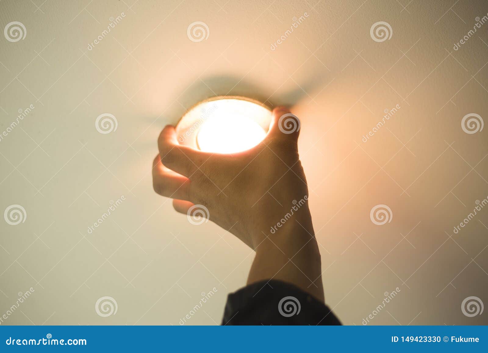 Installation of Point Light, Hand Inserts the Lamp into the Ceiling ...