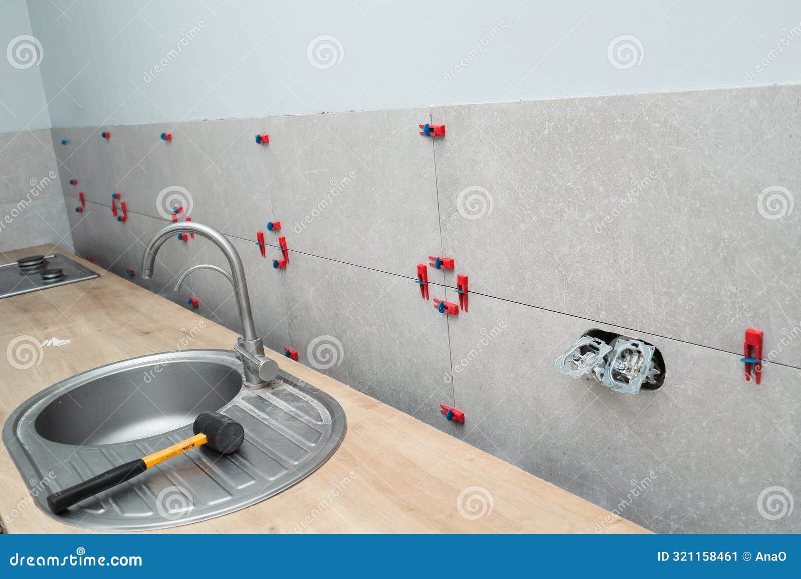 Installation of Porcelain Tiles on the Wall. Tile Leveling System Stock ...