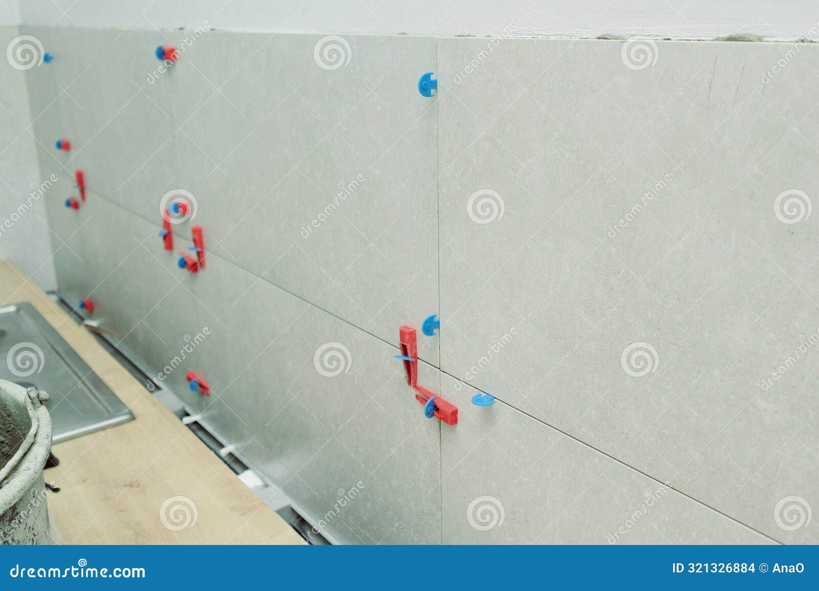 Installation of Porcelain Tiles on the Wall. Tile Leveling System Stock ...