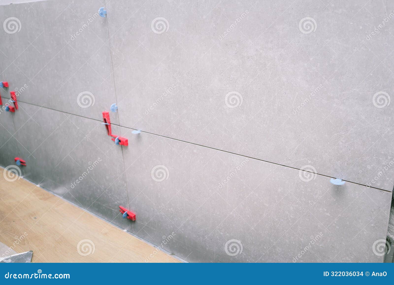 Installation of Porcelain Tiles on the Wall. Tile Leveling System Stock ...
