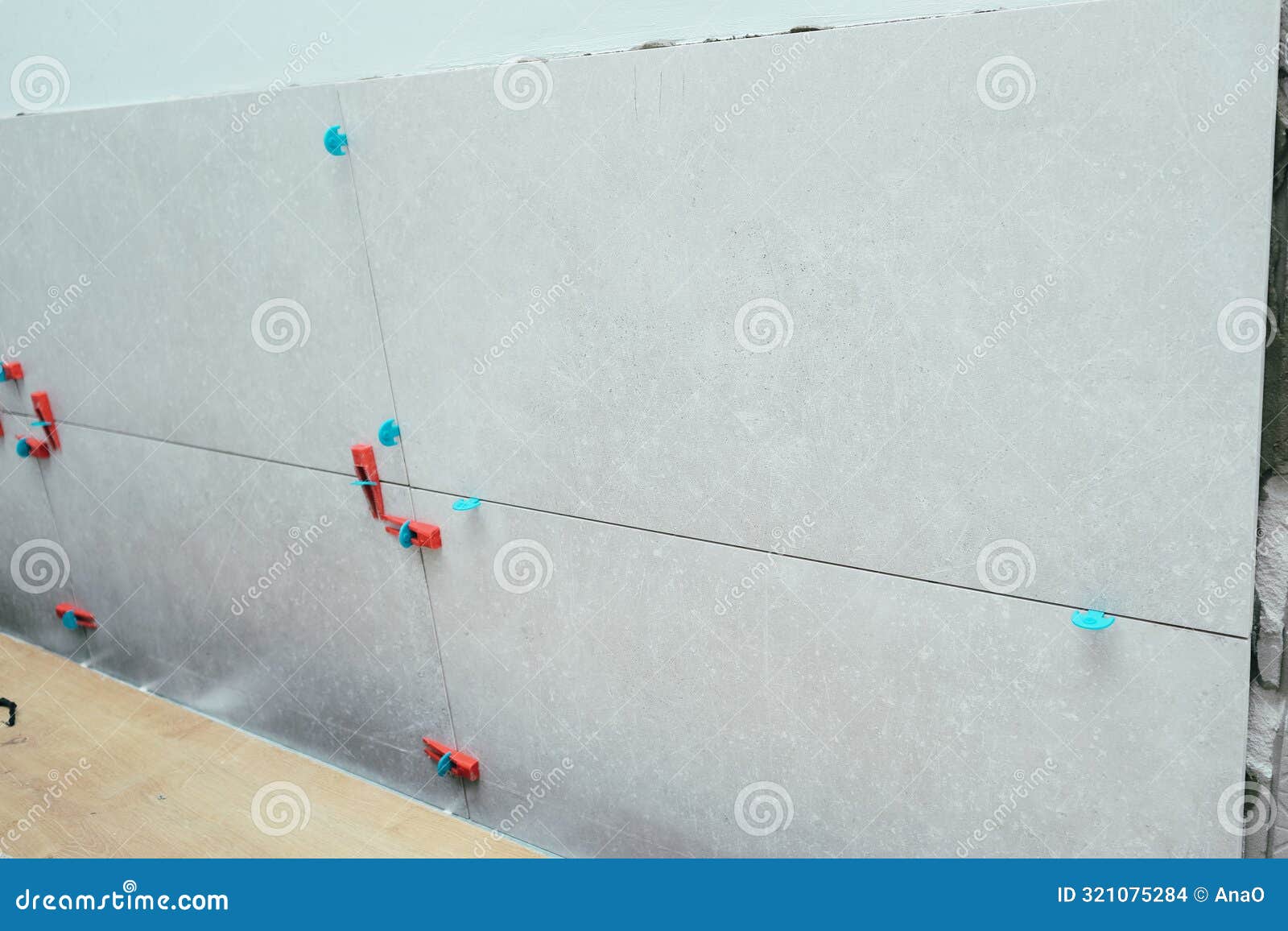 Installation of Porcelain Tiles on the Wall. Tile Leveling System Stock ...