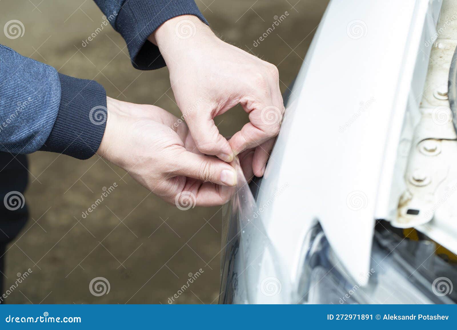 Installation of a Protective Film for Car Paint.the Workers Install a ...