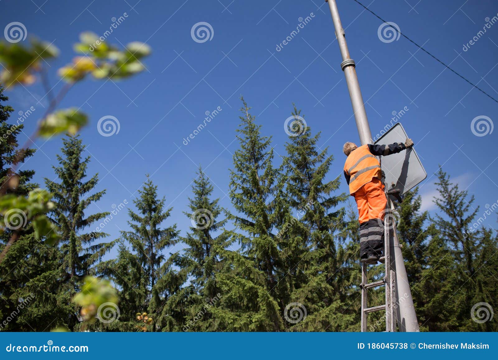Installation Road Sign on Pole. Road Worker Sets Sign. Editorial Stock ...