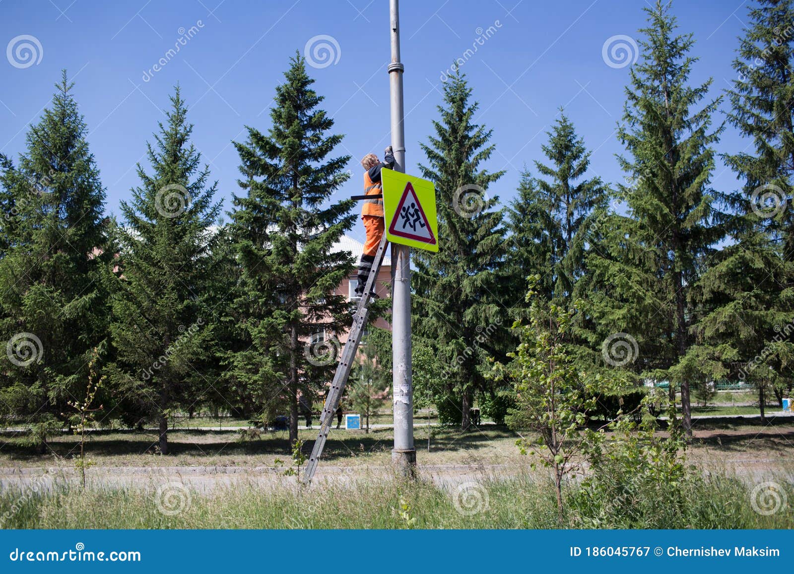Installation Road Sign on Pole. Road Worker Sets Sign. Stock Image ...