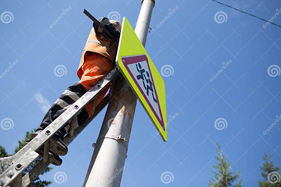 Installation Road Sign on Pole. Road Worker Sets Sign. Stock Photo ...