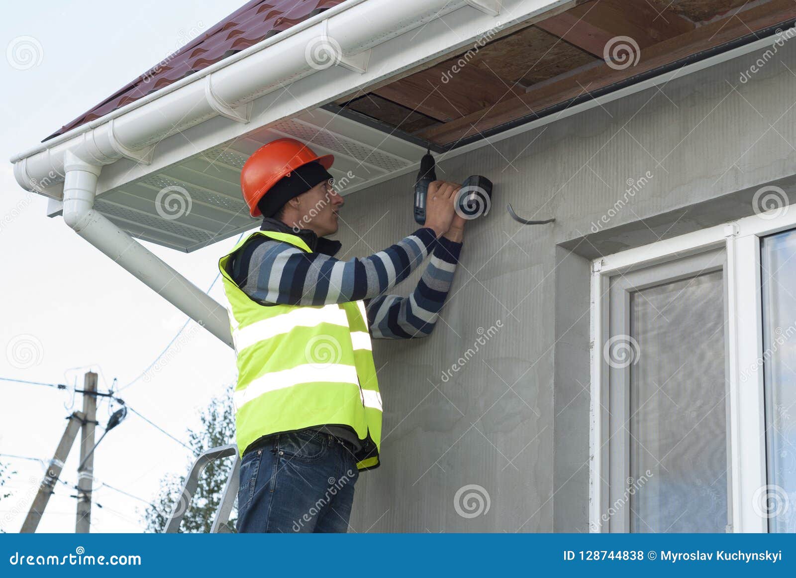 Installation of soffits stock photo. Image of roofer - 128744838