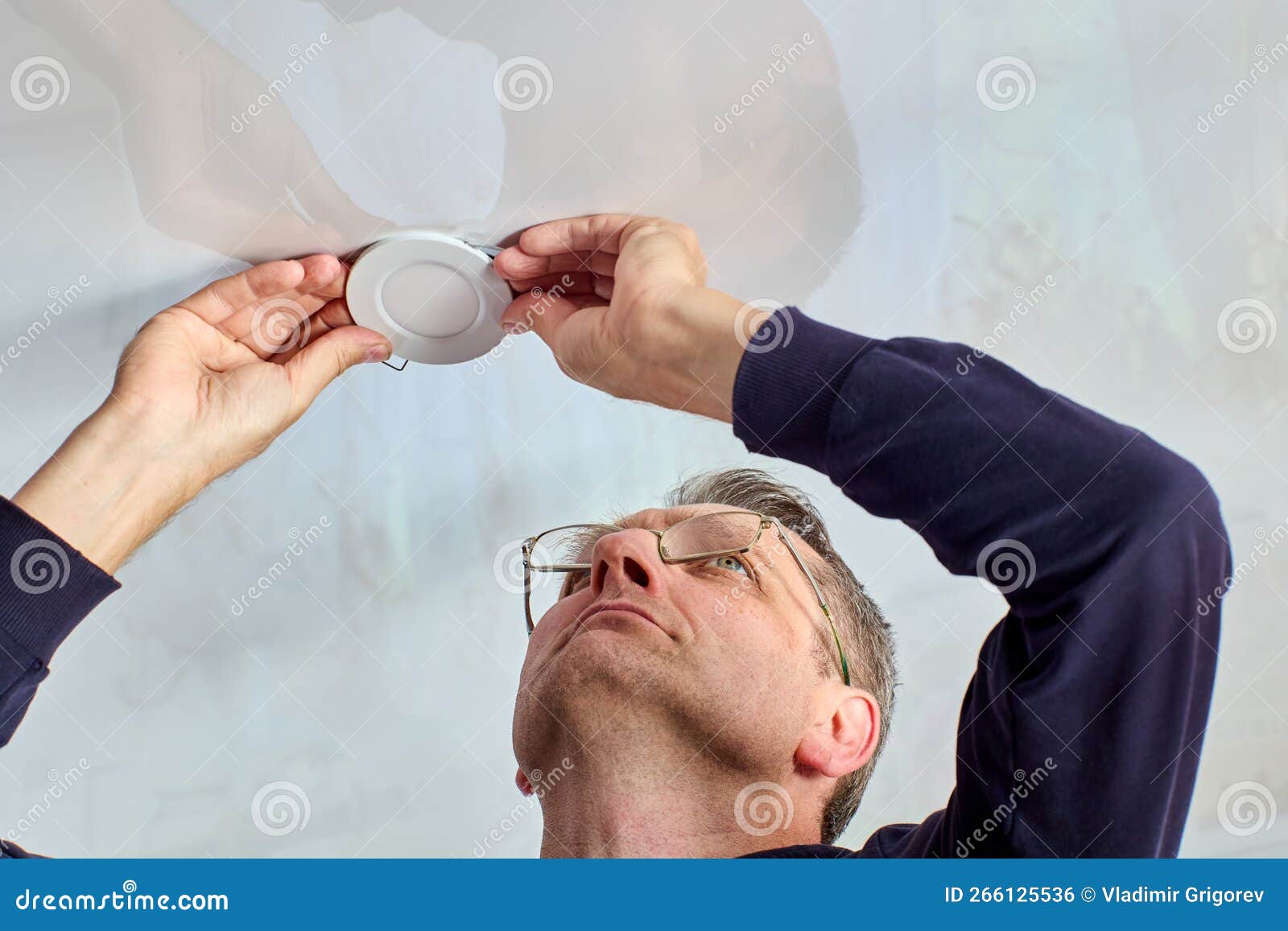 Installation of Spot LED Lamp with Clasp in Stretch Ceiling. Stock ...