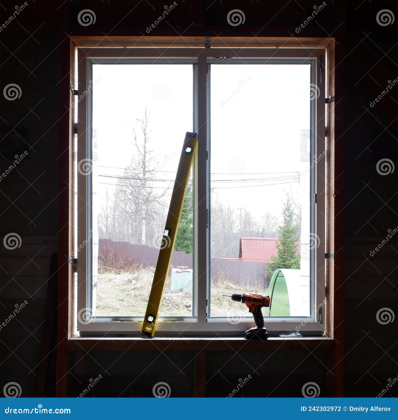 Installation of Windows in a Frame House. the Level and the Screwdriver ...