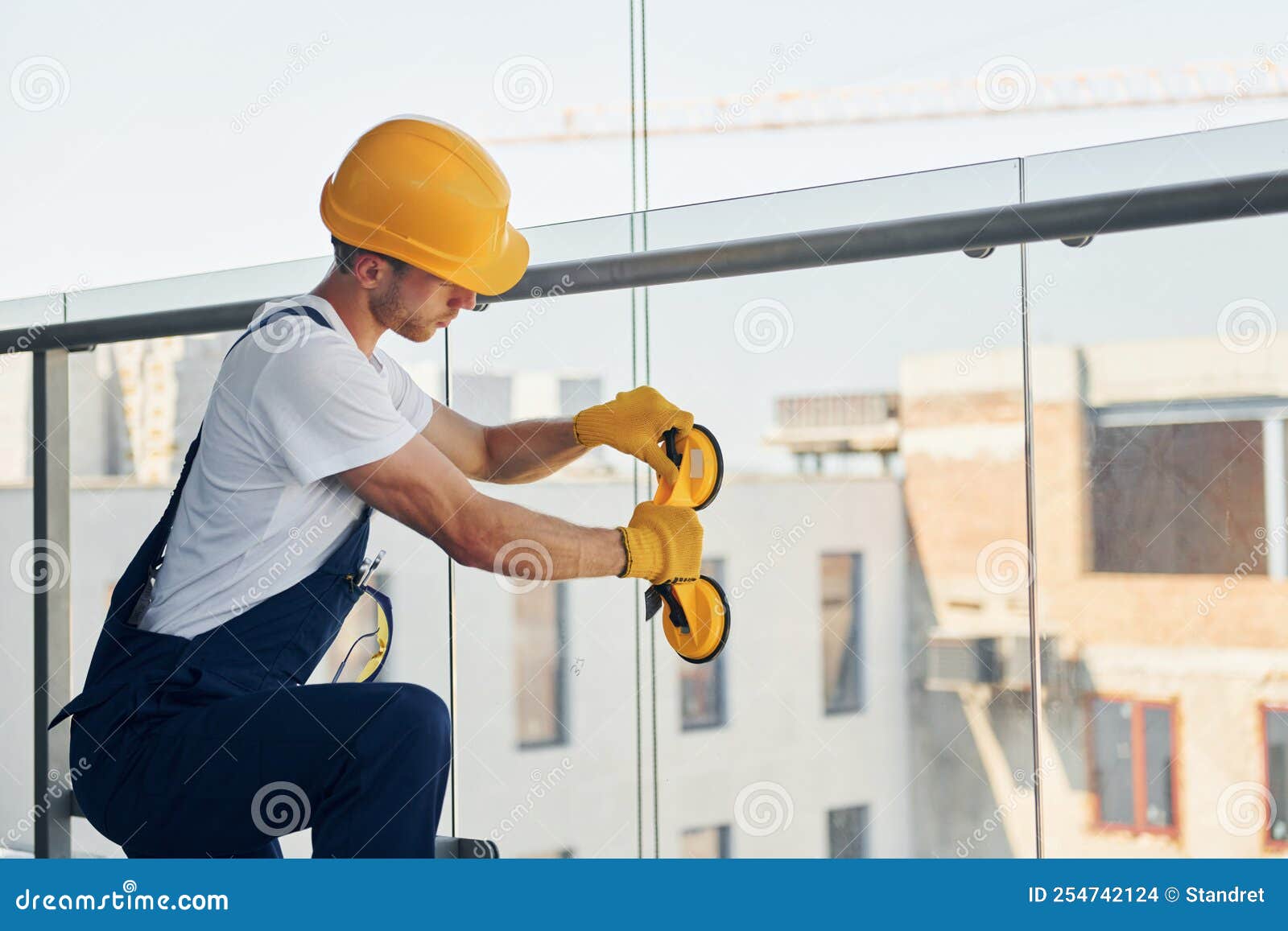 Installation of Windows. Young Man Working in Uniform at Construction ...