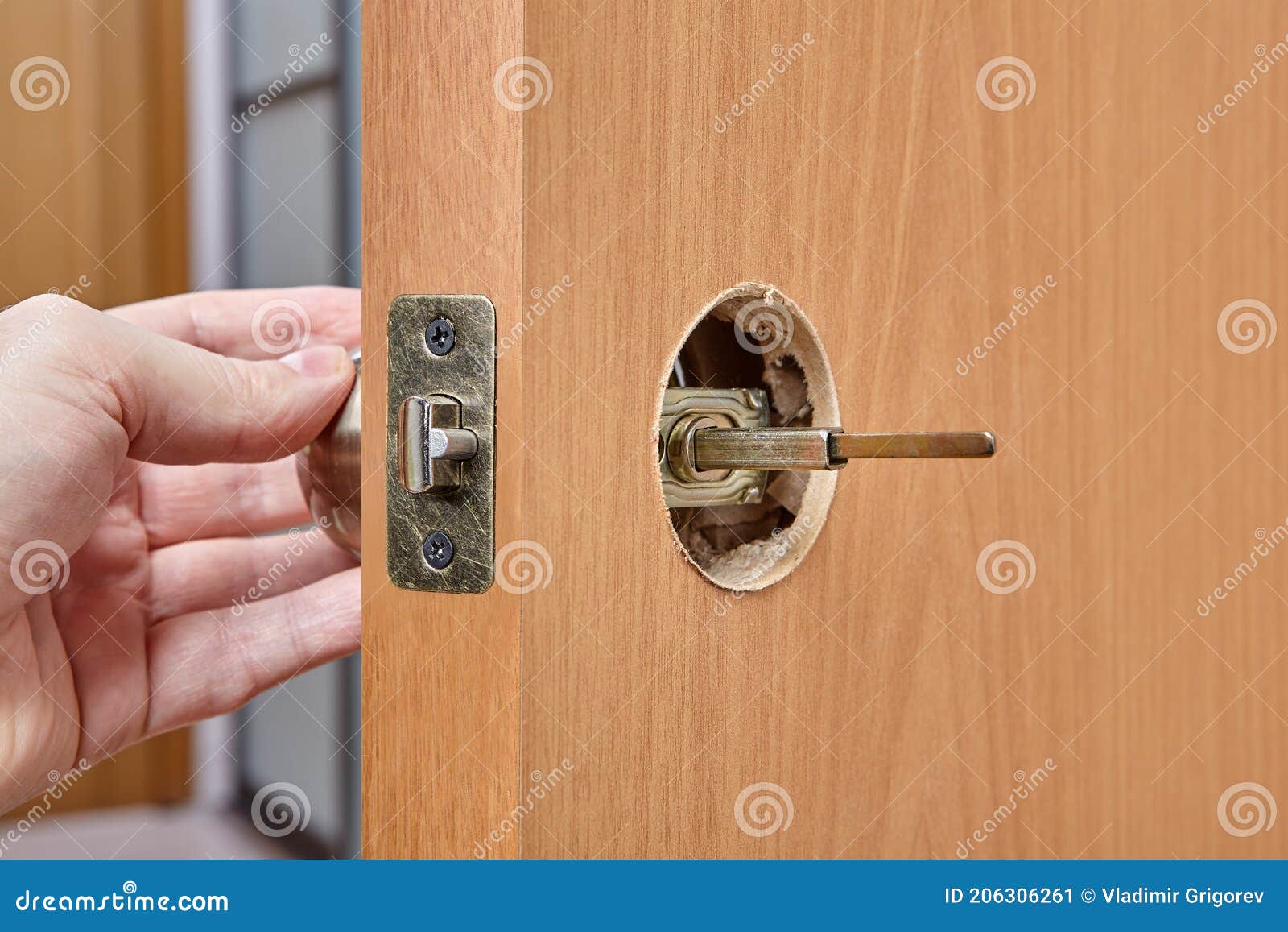 Handyman Pushes The Door Knob Spindle Through The Face Bore And The ...
