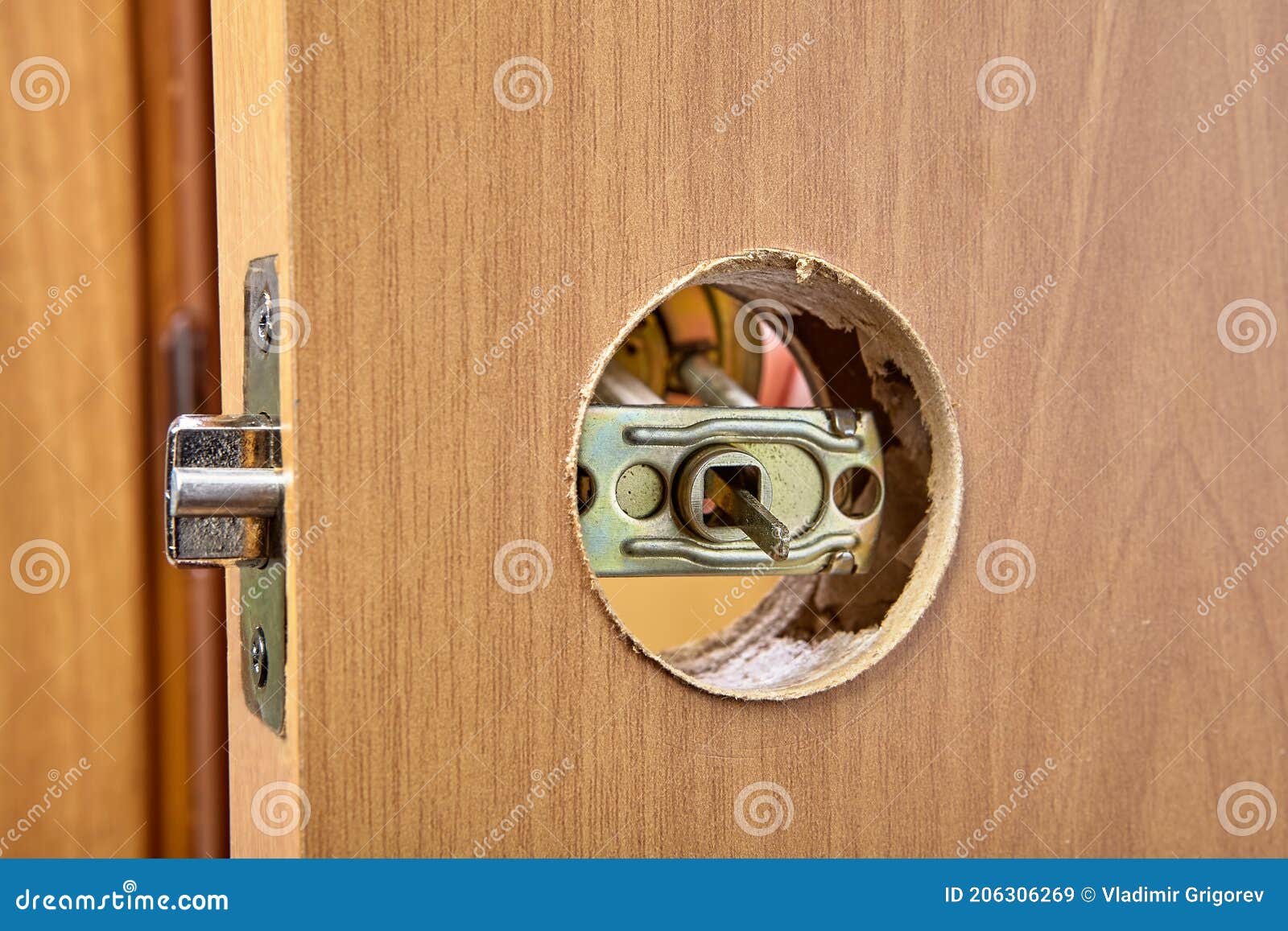 The Installer Pushes the Spindle of Door Handle through the Hole in the ...