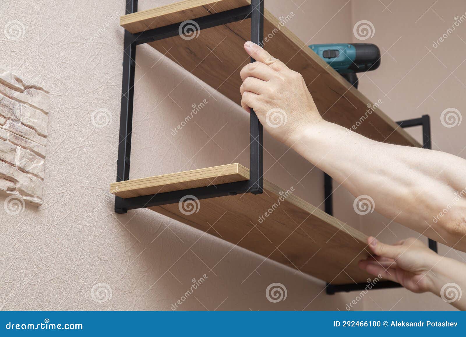 Installing Bookshelves on a Drywall Wall. Self-installation Stock Photo ...