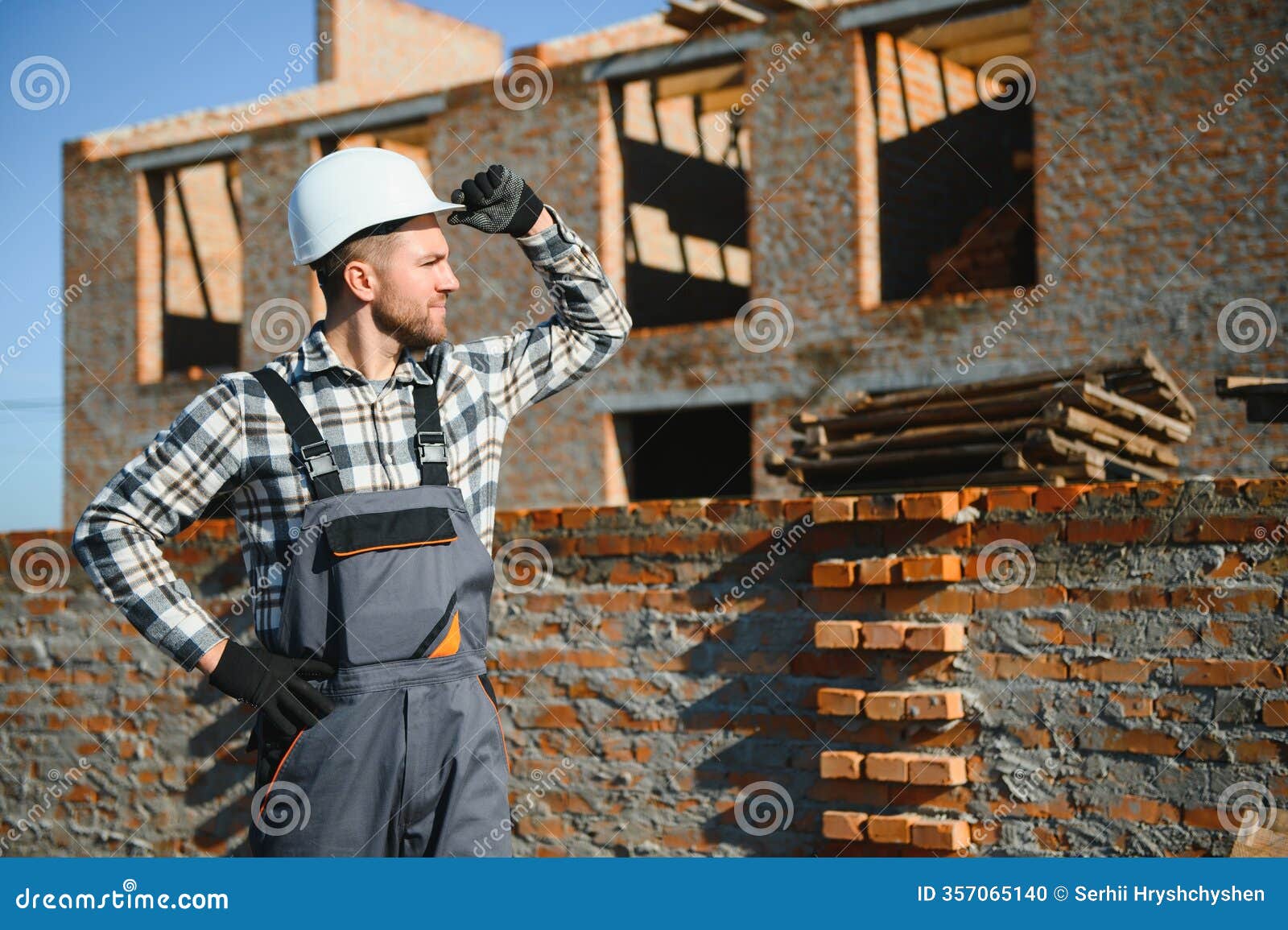 Installing Brick Wall. Construction Worker in Uniform and Safety ...